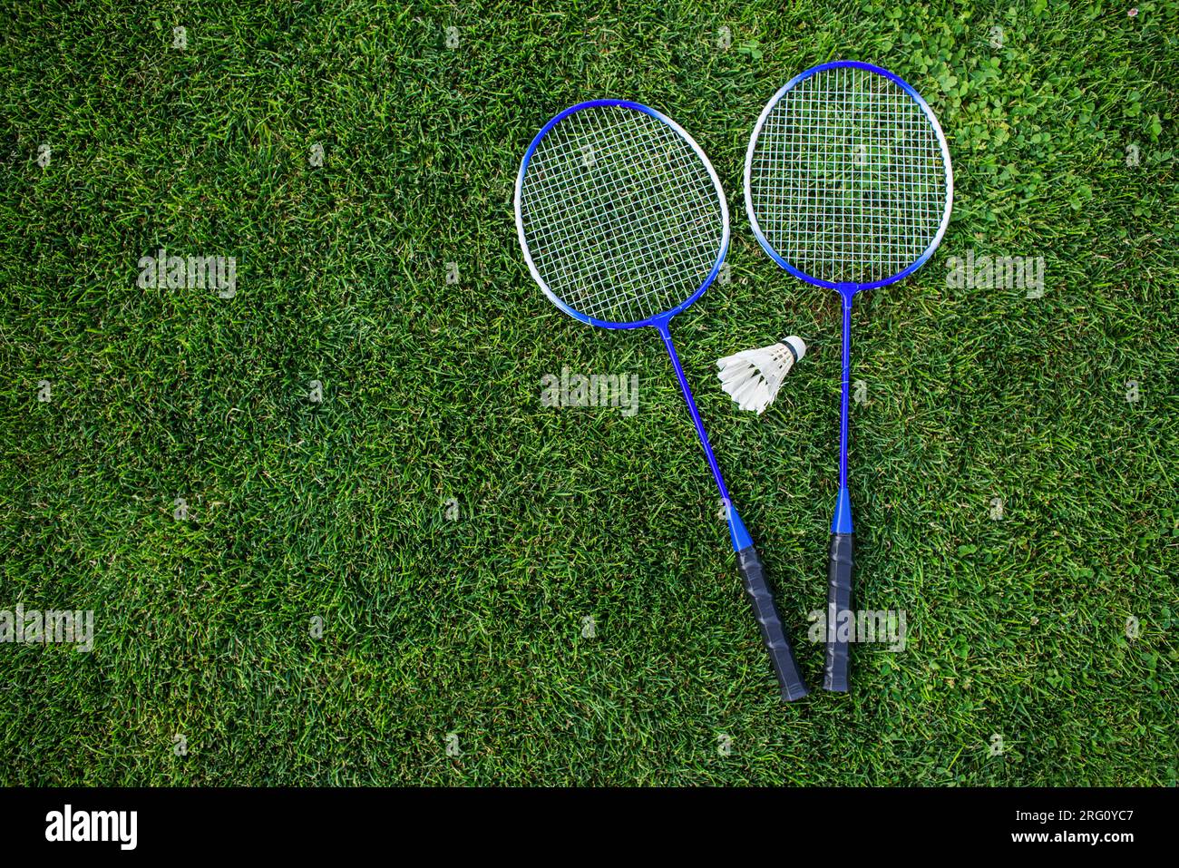 Rackets and a shuttlecock for badminton on the grass. Top view Stock ...