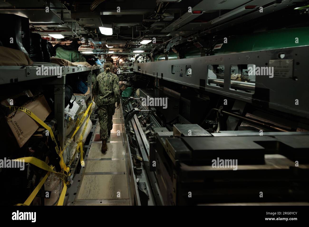 A crew member is seen walking between crew bunk areas (left) and an ...