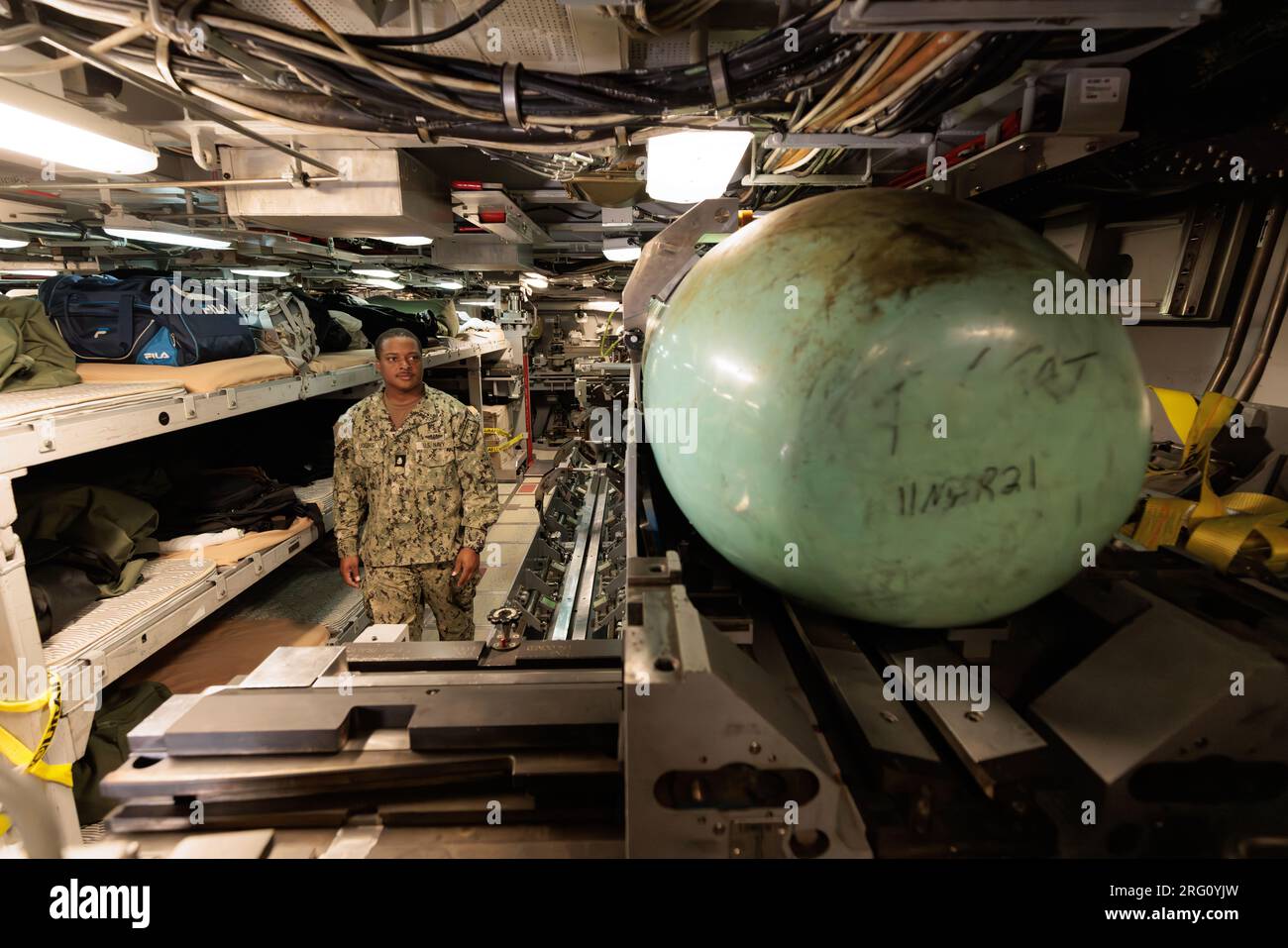 A crew member is seen walking between crew bunk areas (left) and an ...