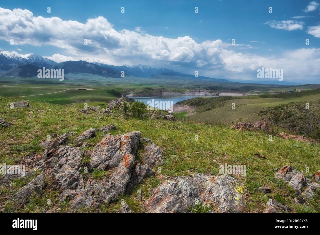Green Valley in front of the mountains with a lake. Bestobe reservoir ...