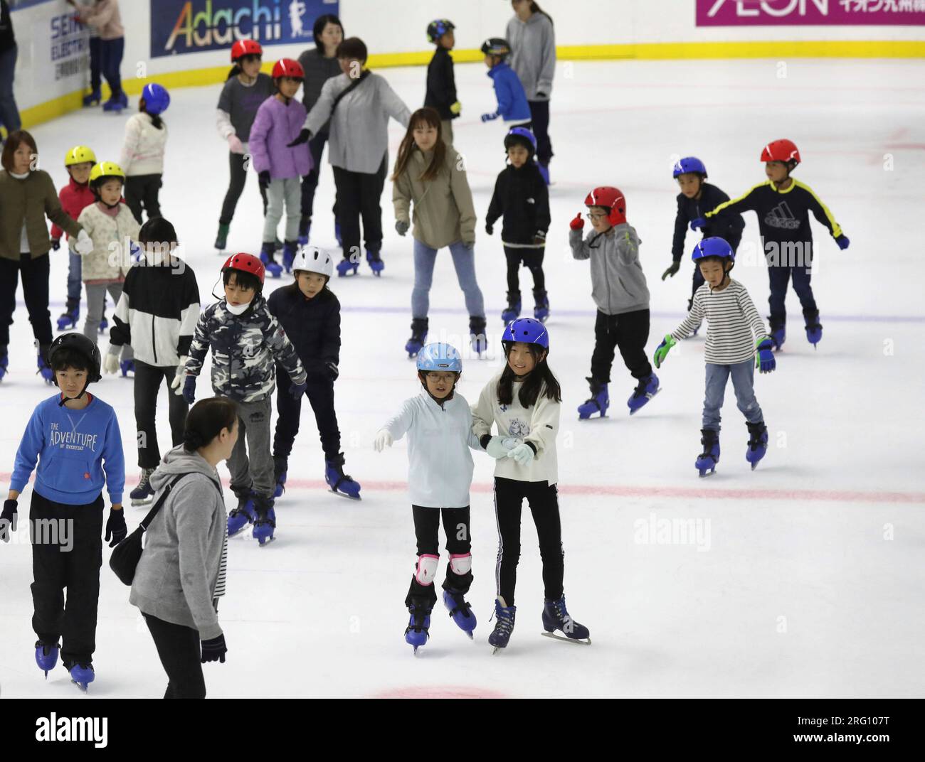 A skating rink is crowded with children at O-vision Ice Arena Fukuoka ...