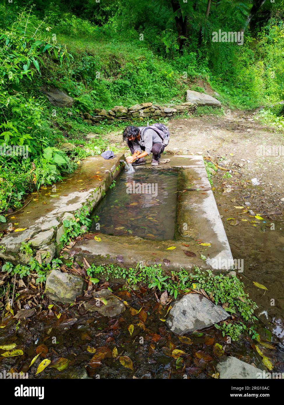 October 14th 2022, Uttarakhand India. A tired male trekker drinking ...
