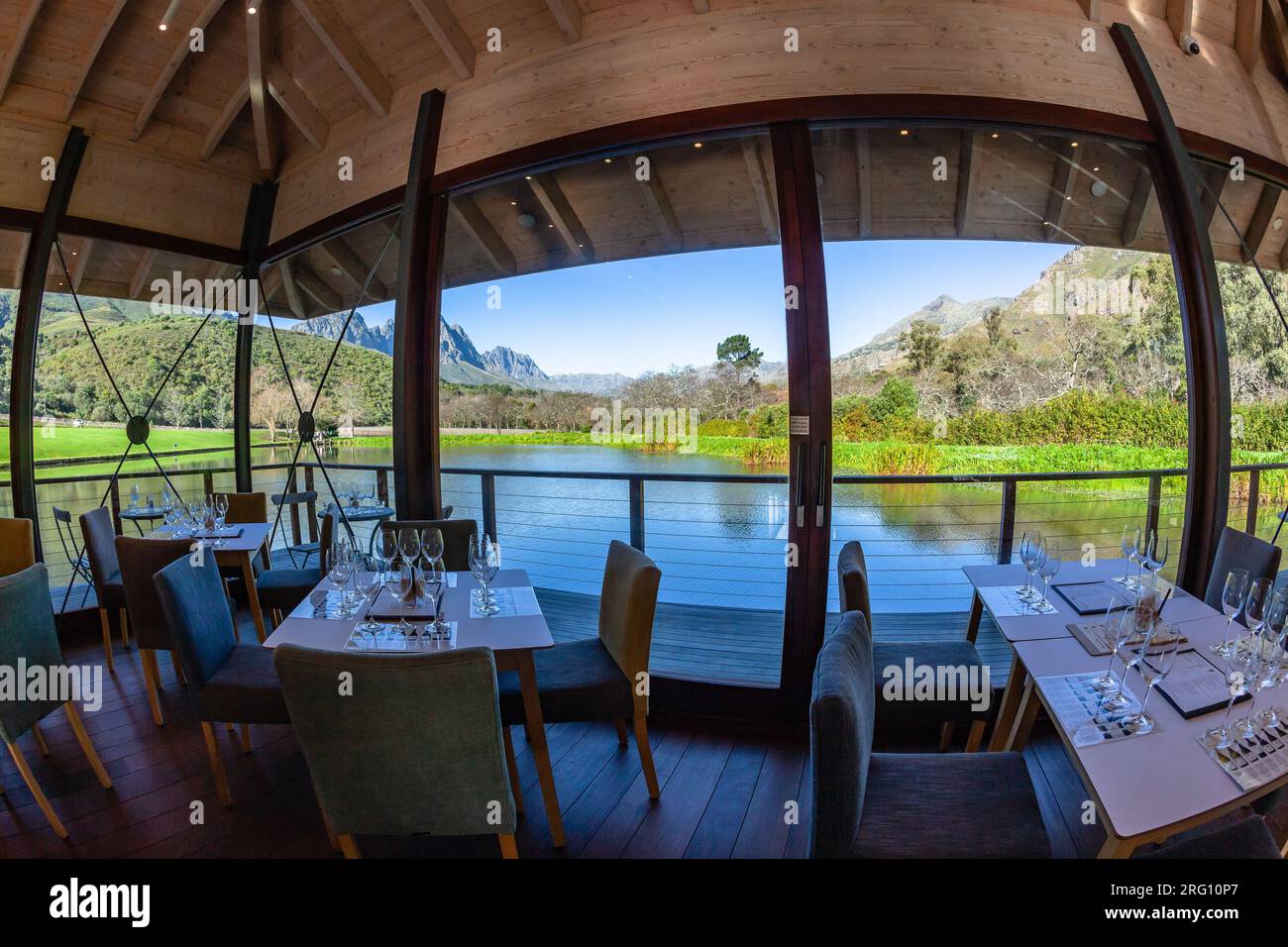 Scenic view from inside lake house restaurant with wine glasses tables ...