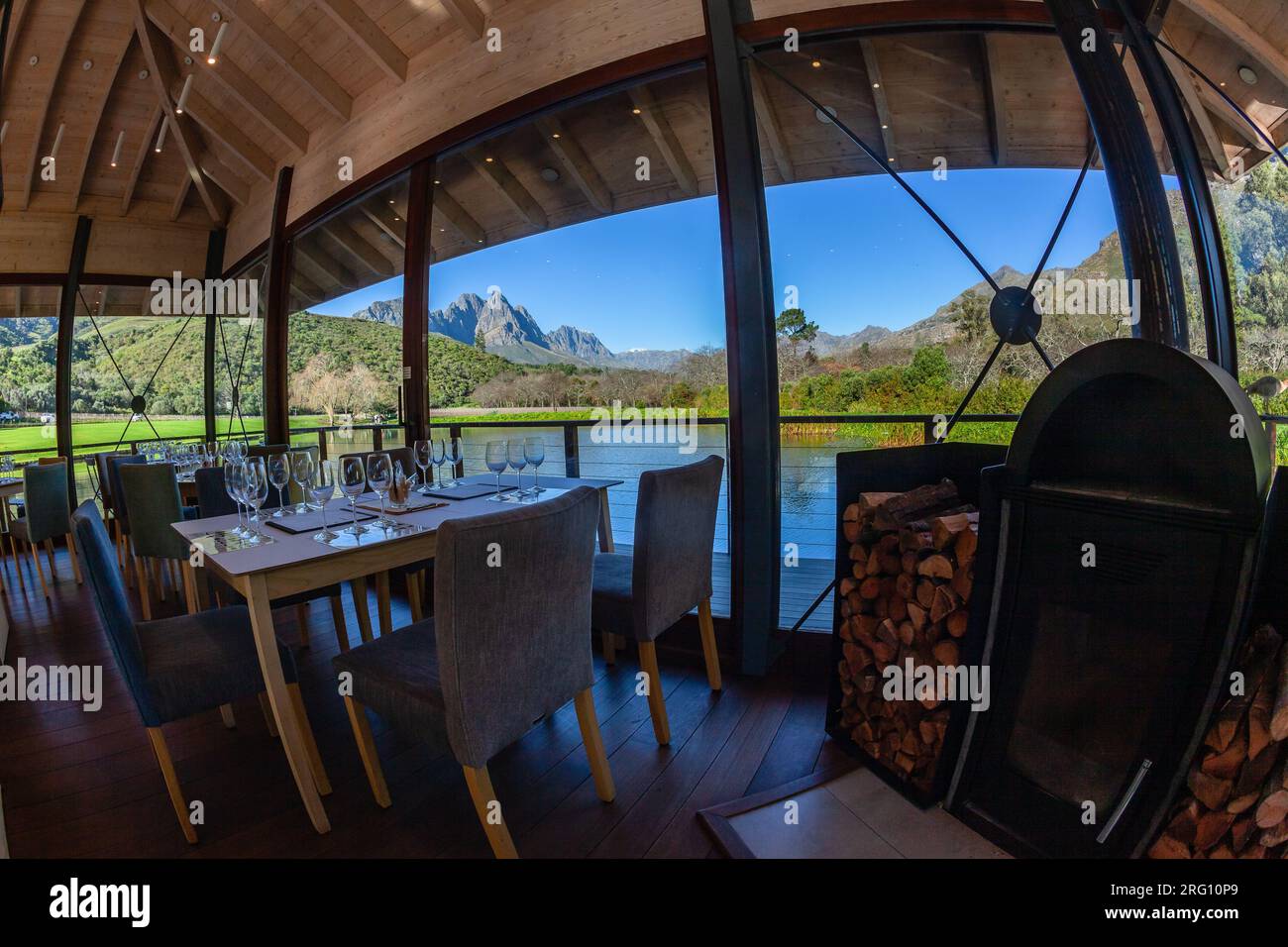 Scenic view from inside lake house restaurant with wine glasses tables ...