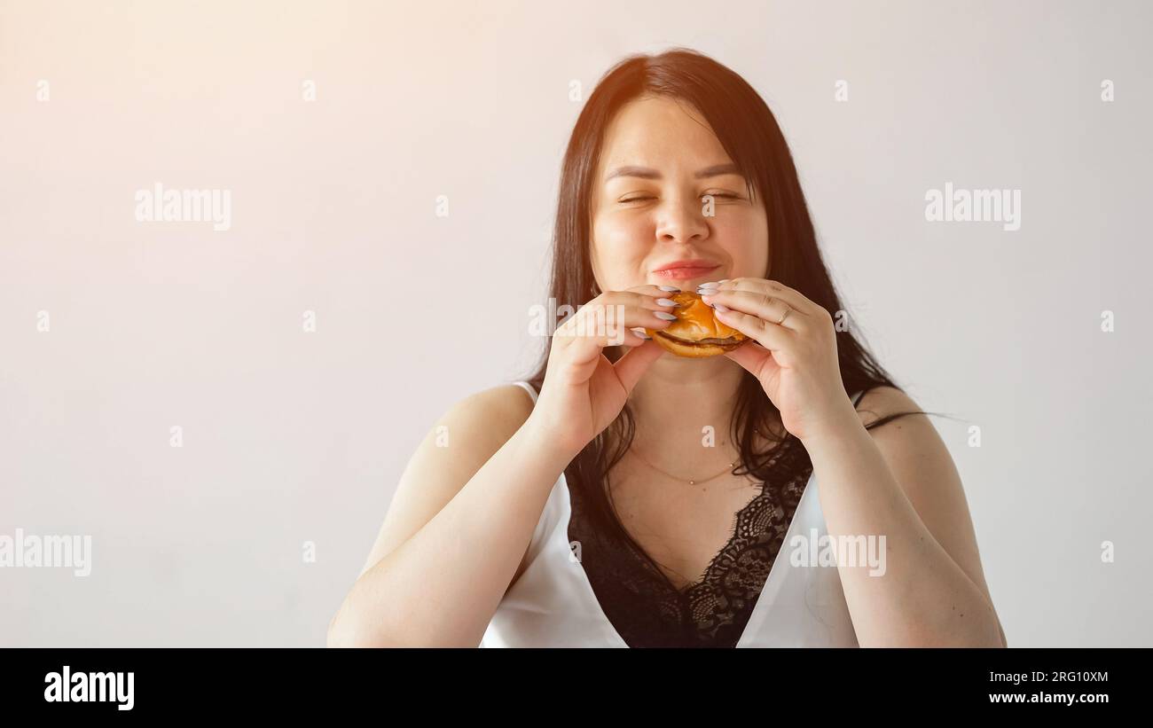 Woman tries to choose between healthy and unhealthy diet Stock Photo ...