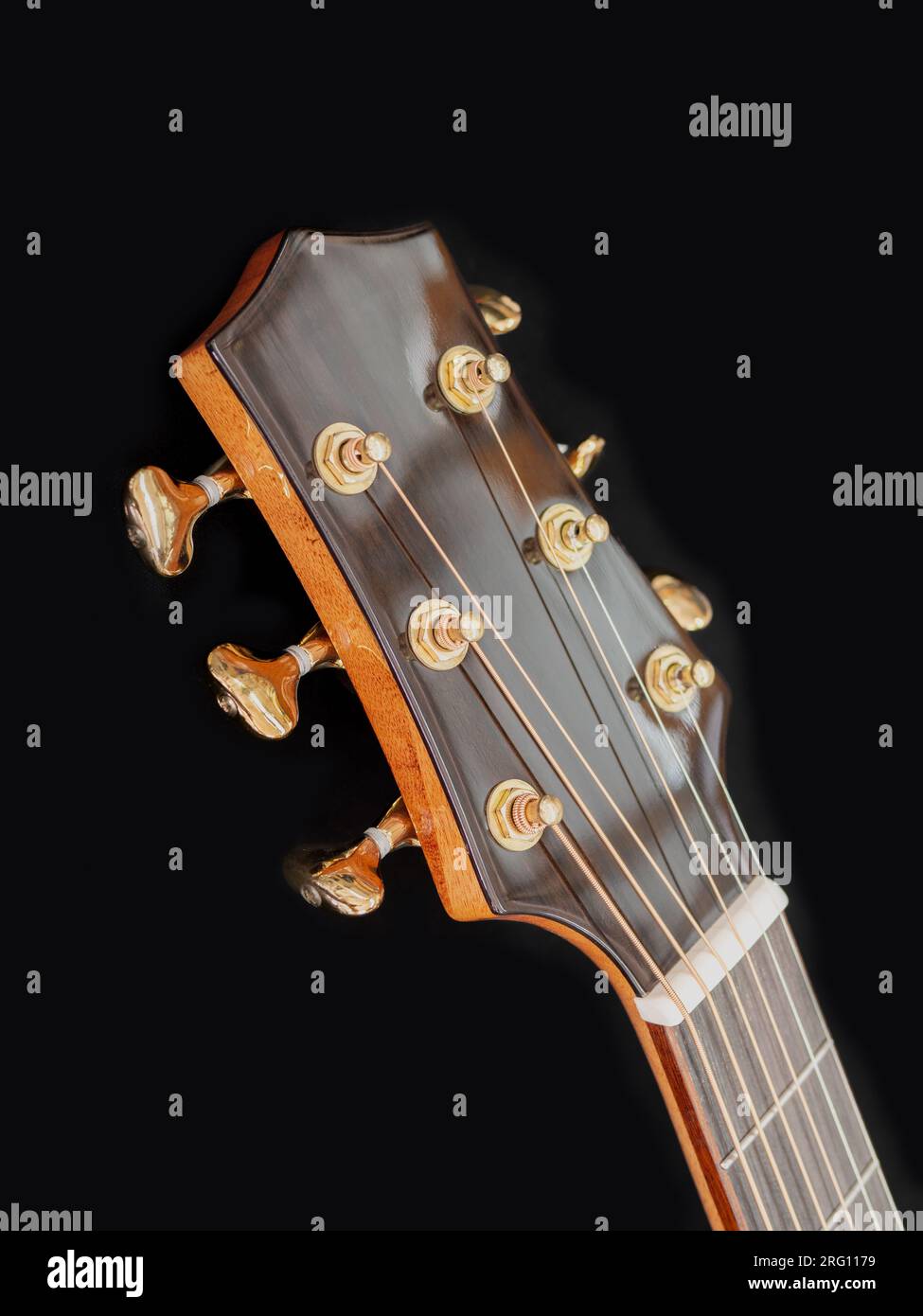 The neck of a six-string acoustic guitar on a dark background . guitar ...