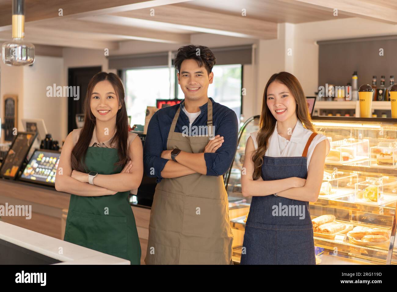 Smiling waitress crossed arms hi-res stock photography and images - Alamy