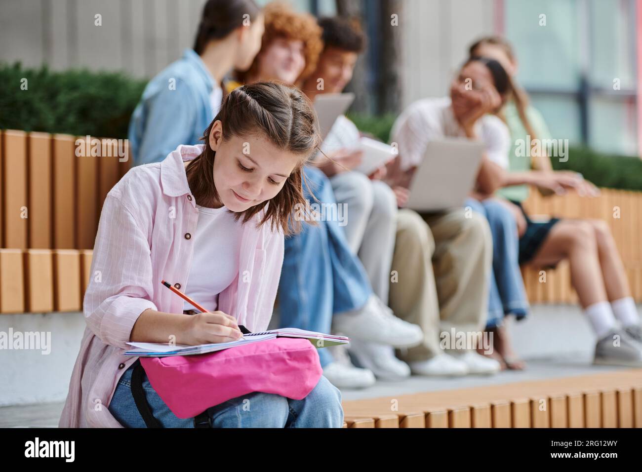 back to school, teenage girl taking notes near classmates and teacher ...
