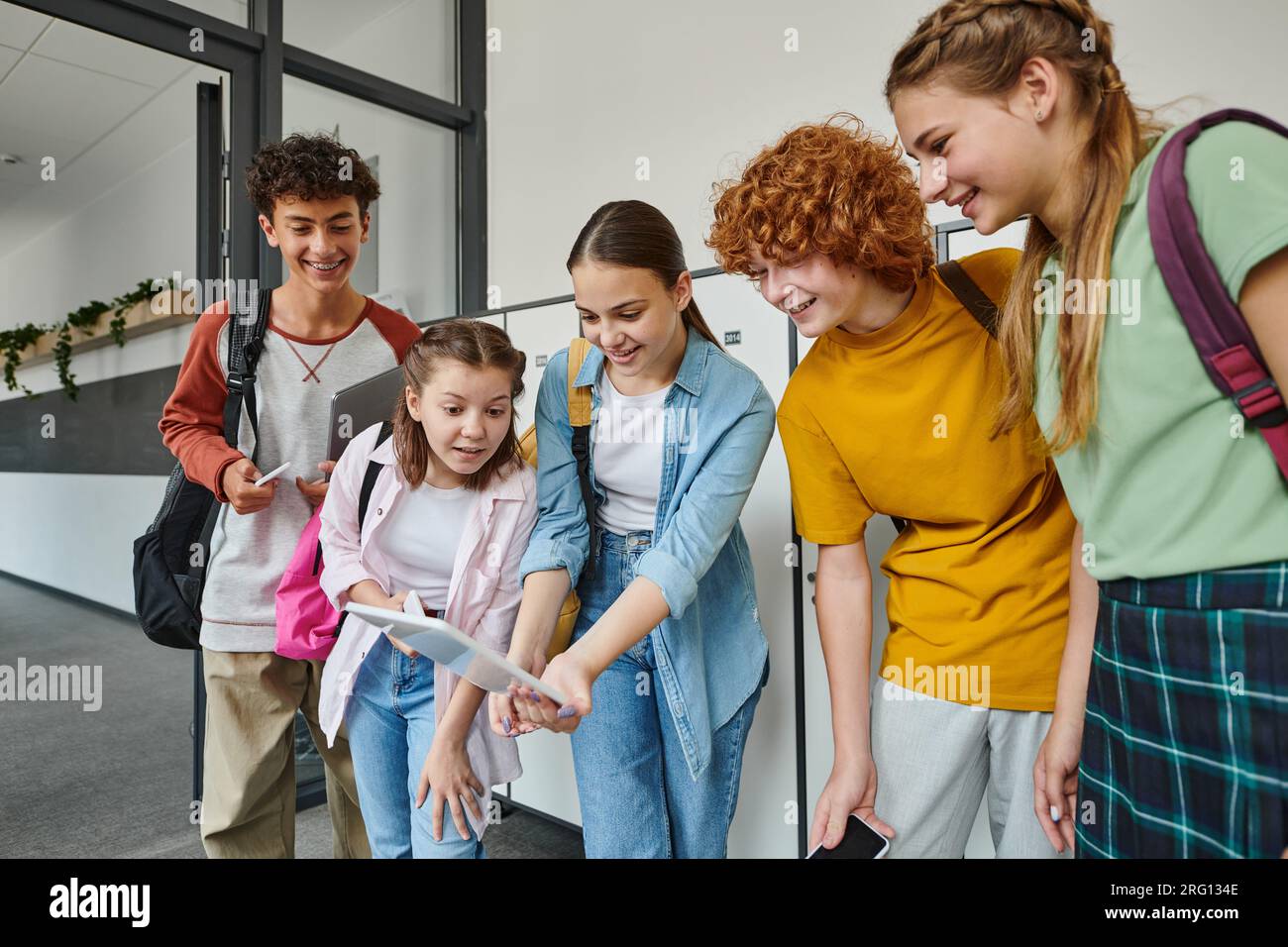 happy teenage students looking at digital tablet together, education ...