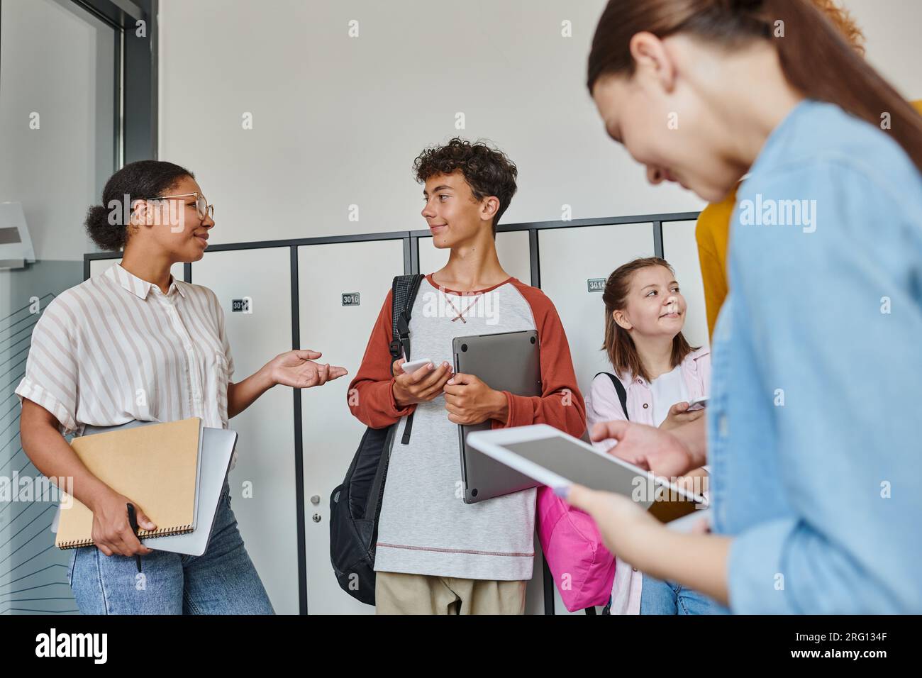 Teacher Talking To Student In Hallway