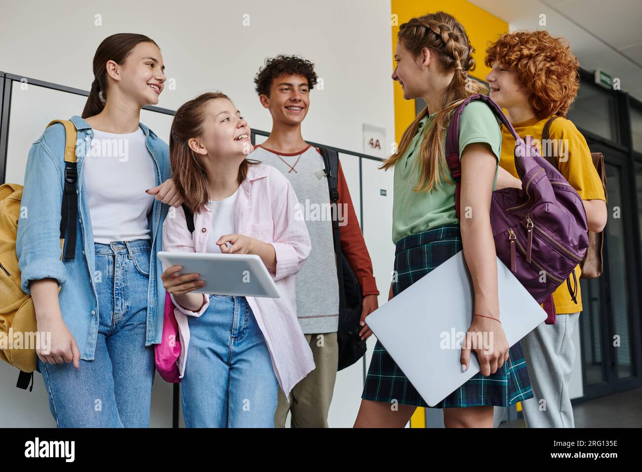 Teen girls in jeans looking at laptop hi-res stock photography and ...
