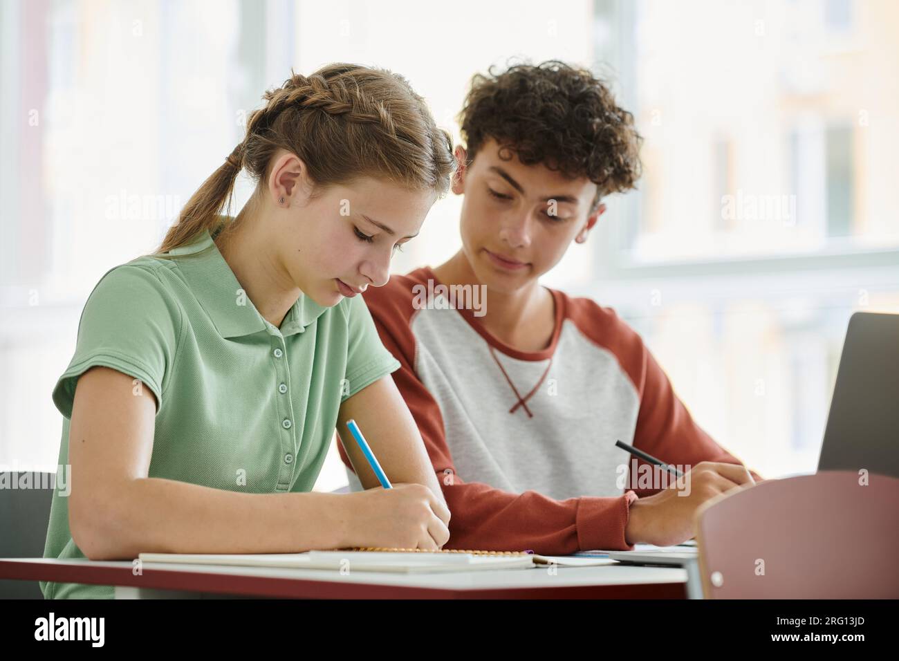 Teen boy writing classroom hi-res stock photography and images - Alamy