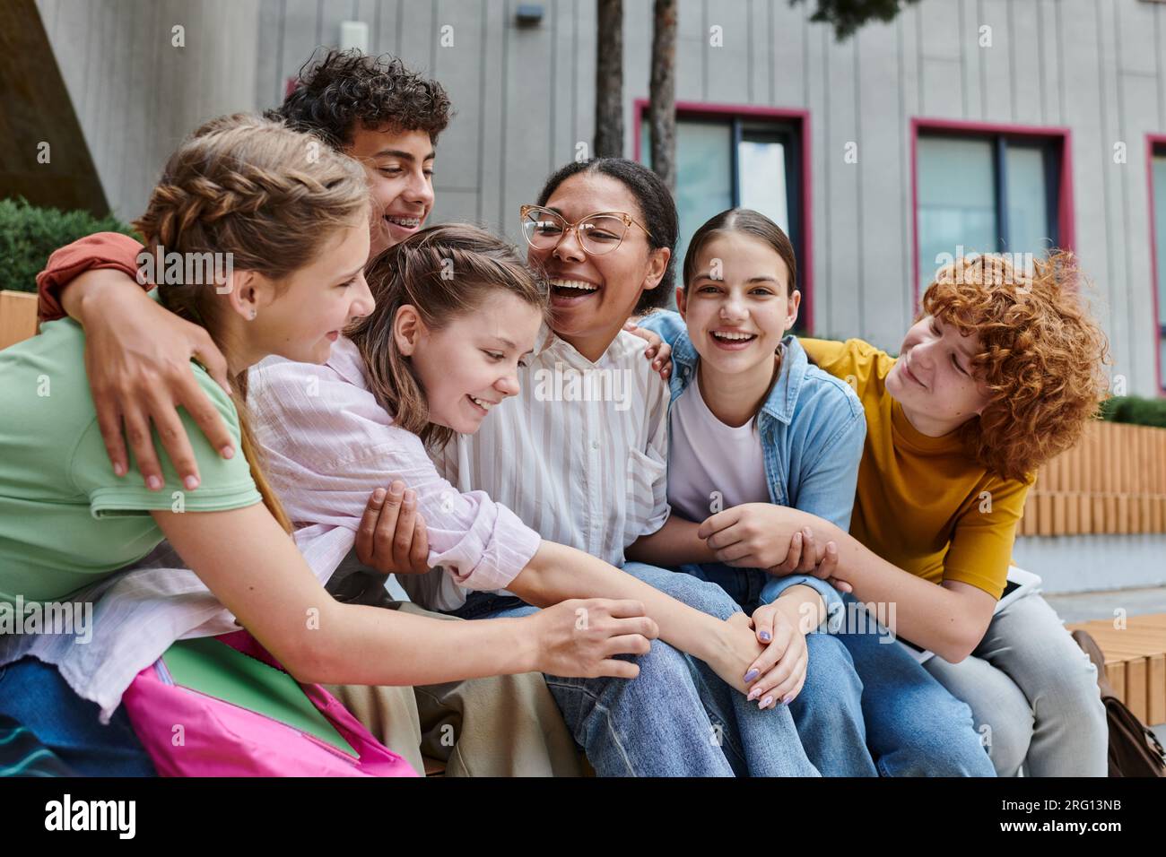 happy african american woman hugging with teenage students, diversity ...