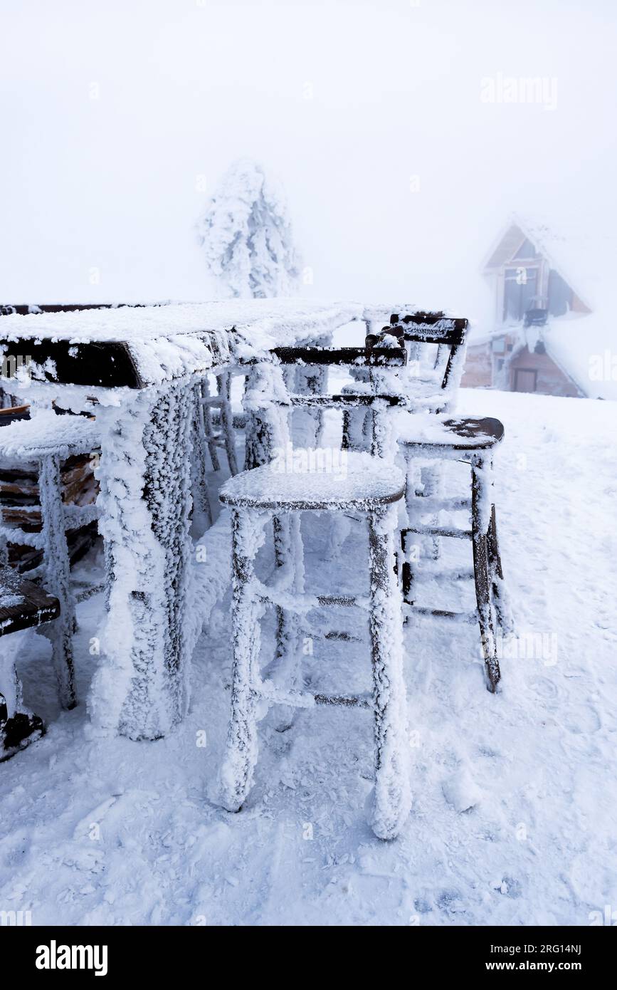 Winter scene in the mountains with snow covered and frozen cottage and ...