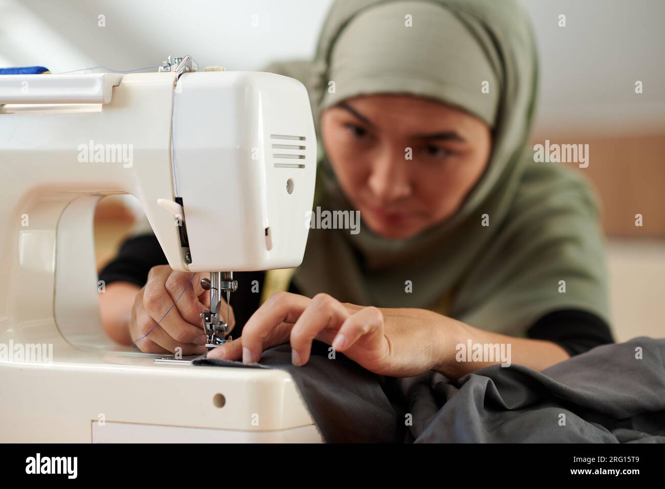 Closeup image of muslim tailor sewing evening gown for client Stock ...