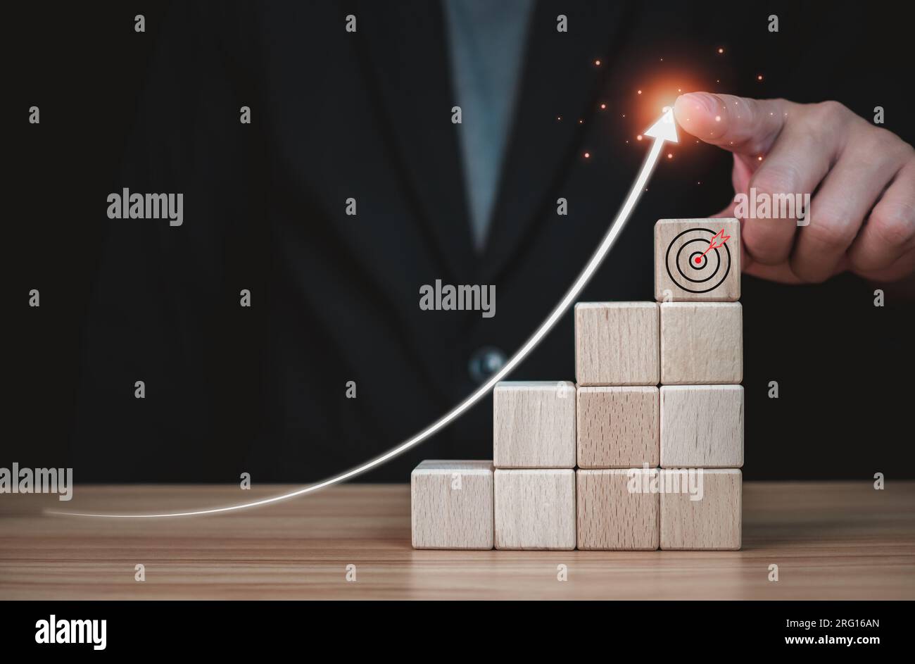 Businessman pin in the selection of target on wooden block which prints ...