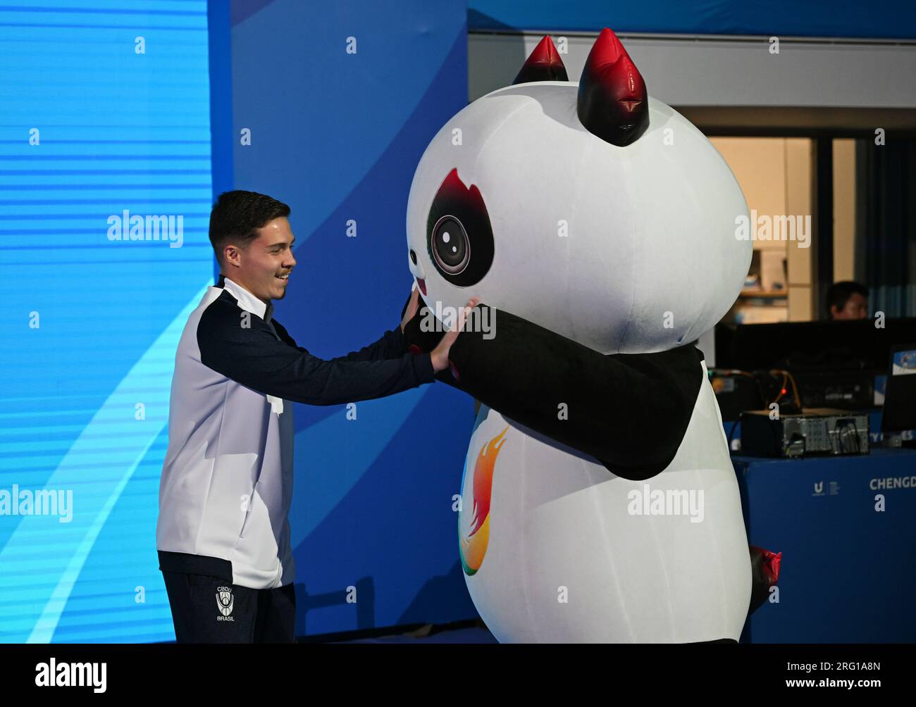 Chengdu. 7th Aug, 2023. Joao Margiotto of Brazil greets the mascot ...