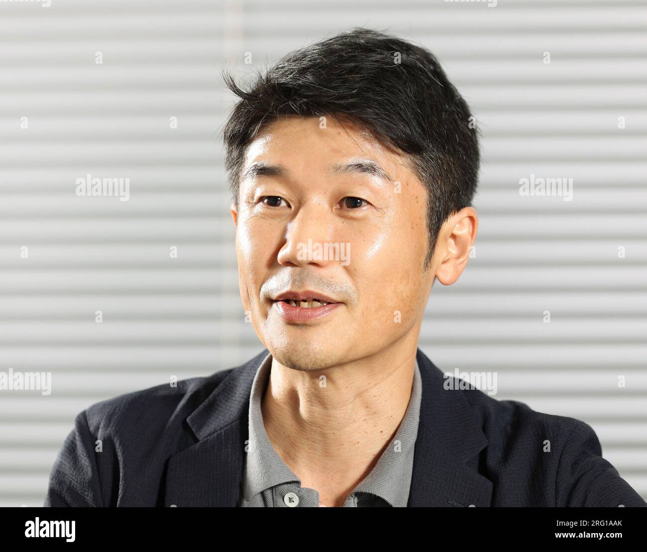 Motoaki Tanigo, President and CEO of COVER, attends an interview in ...