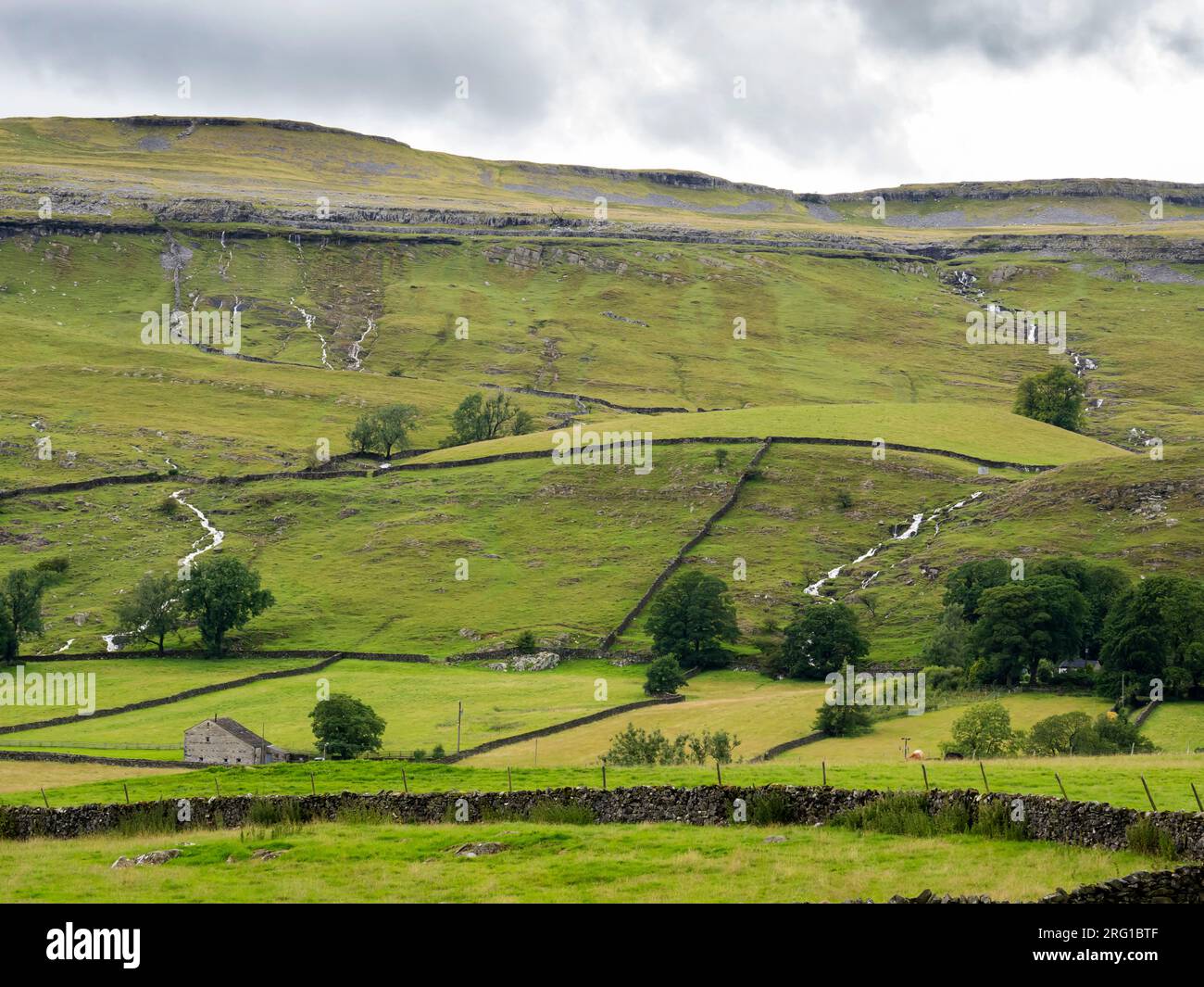 Water flowing from limestone springs after heavy rain above Austwick in ...