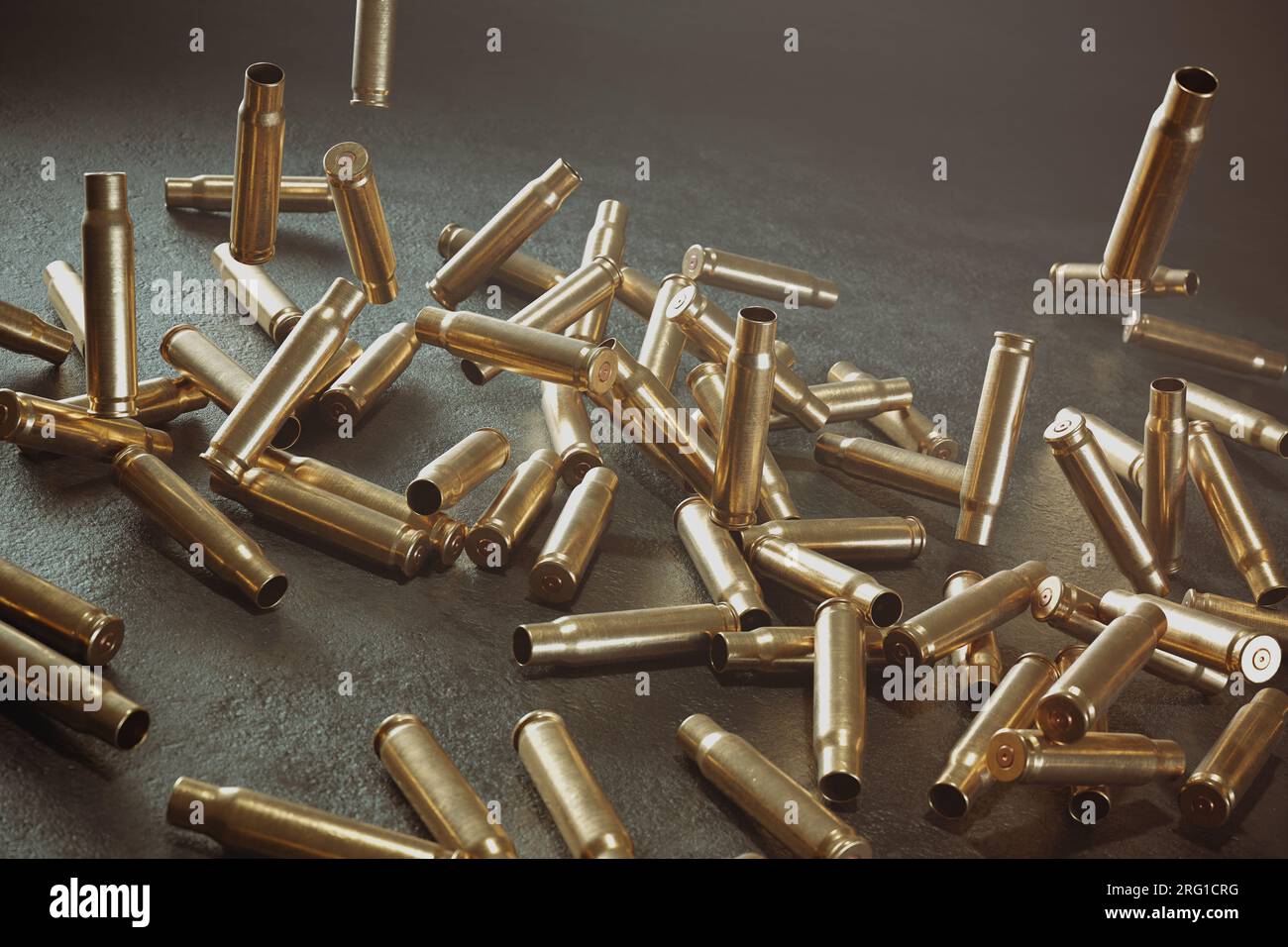 Empty shells falling down on the floor. Gun ammunition. Metal bullets ...