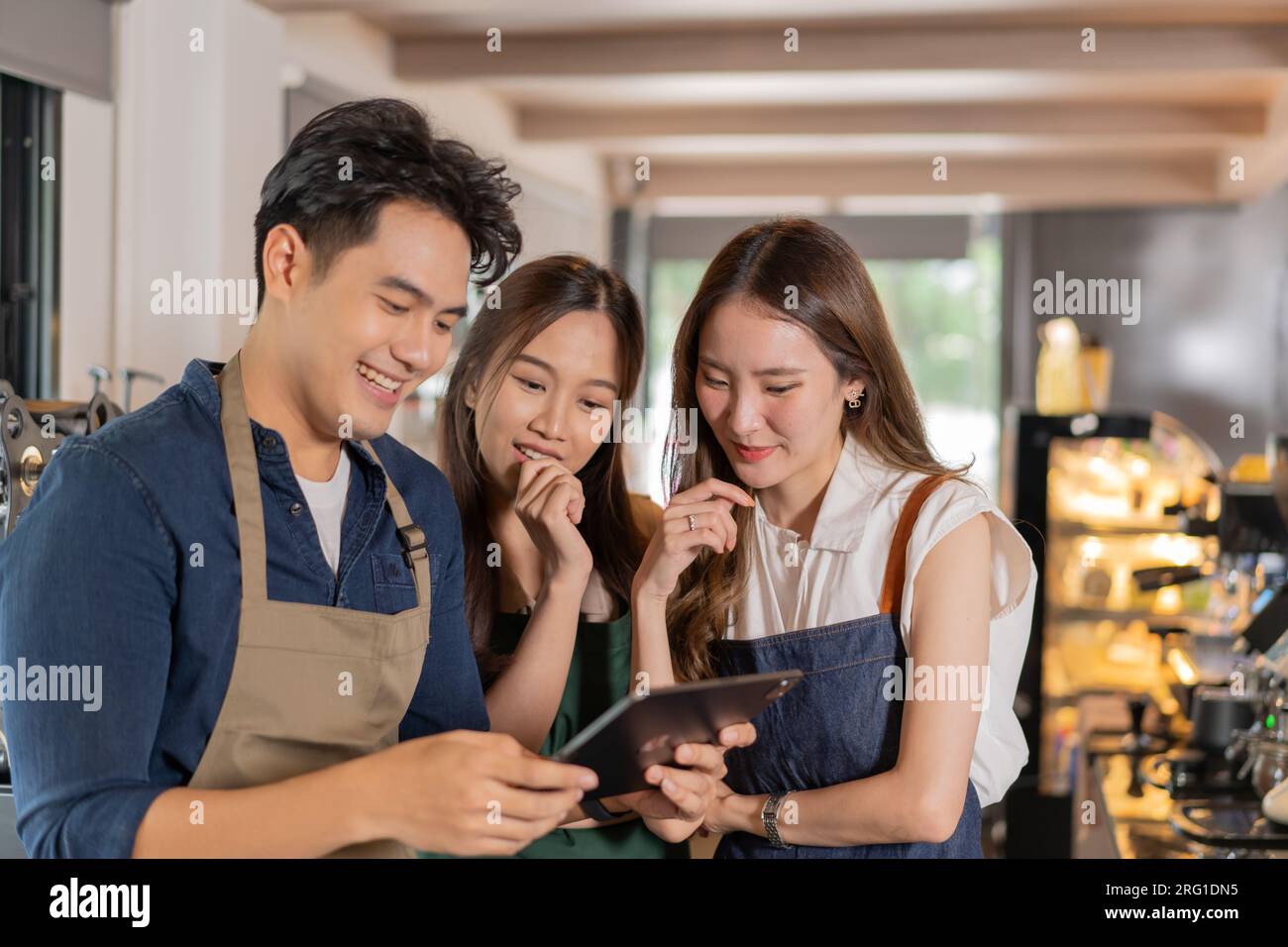 Three barista entrepreneur team meeting at coffee shop. Young smiling ...