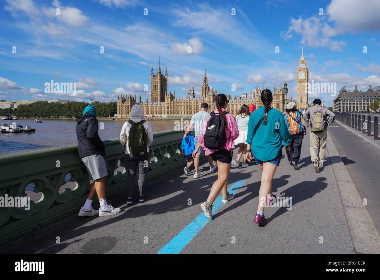 London UK. 7 August 2023 . Pedestrians walking in the bright sunshine ...