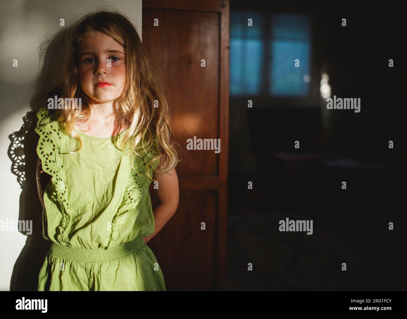 A girl laying back on wall looking forward Stock Photo - Alamy