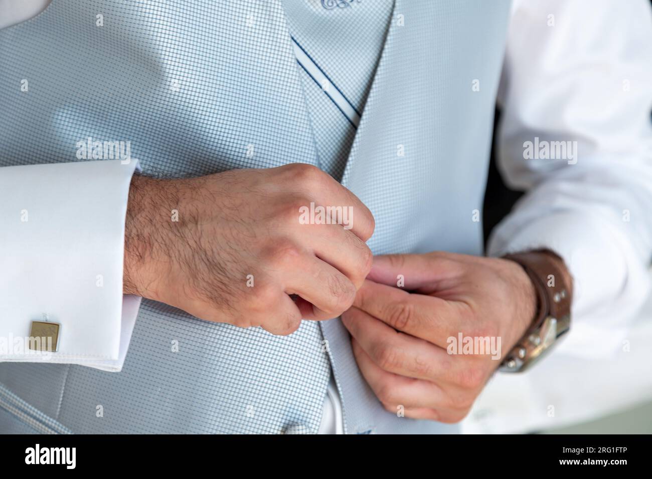 Groom getting dressed and getting ready for his wedding day Stock Photo ...