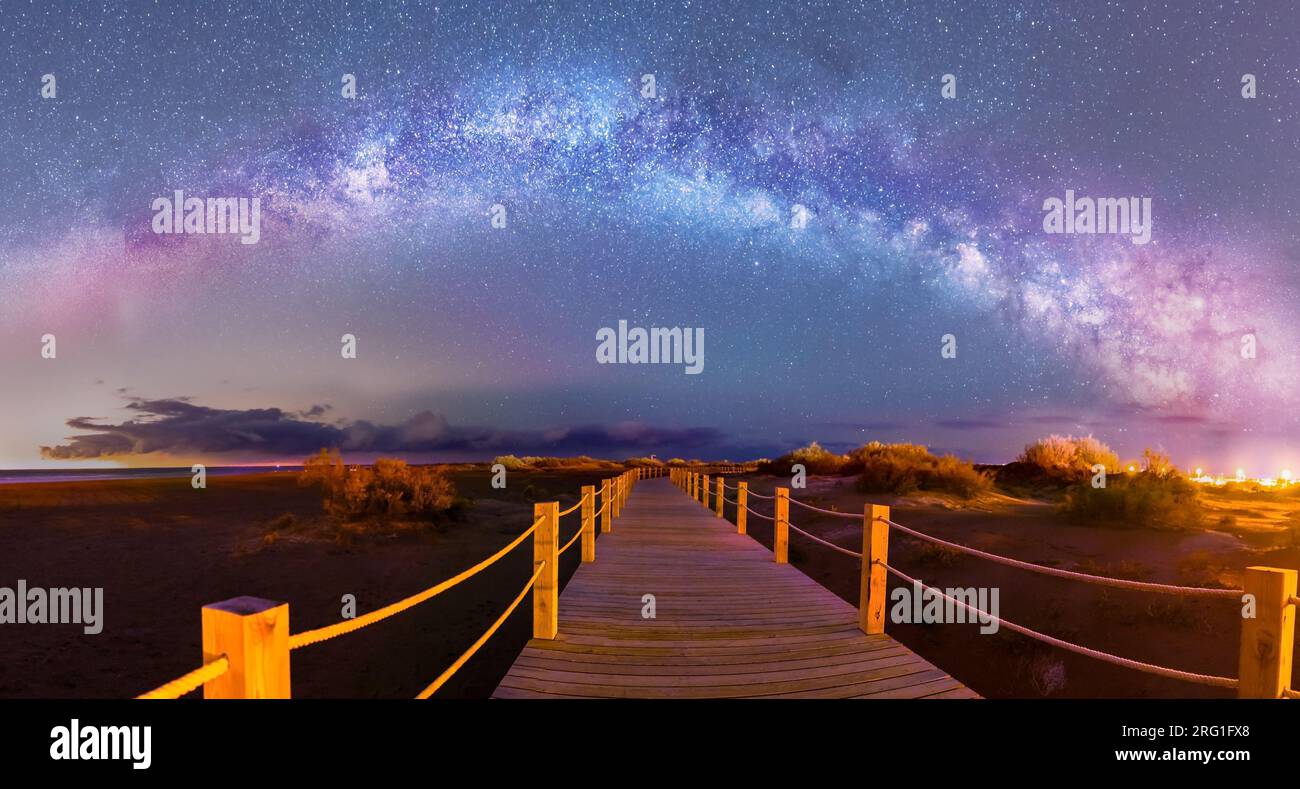 Milky Way Arch over a woden path in Riumar Beach, Catalonia, Spain ...