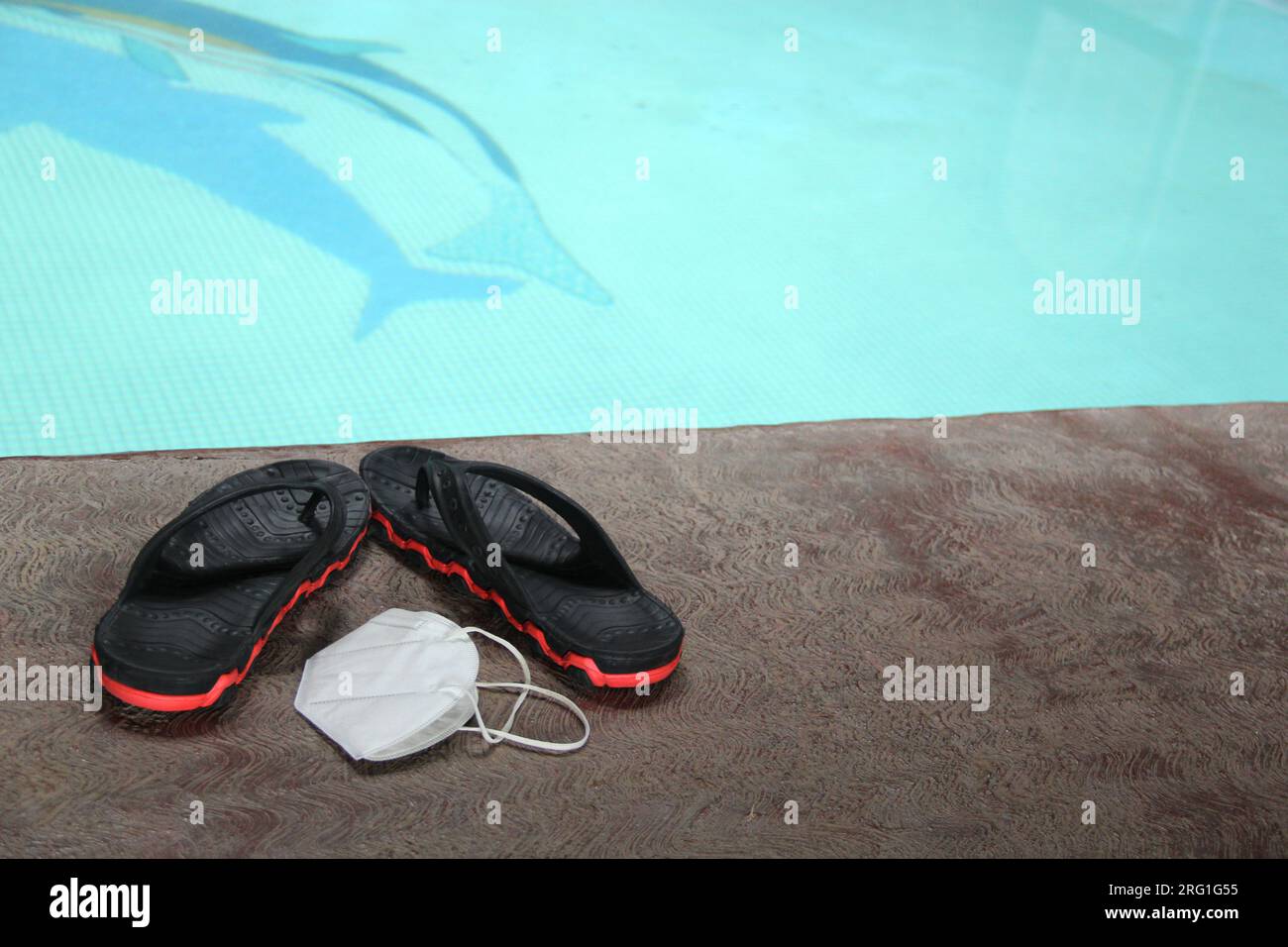 Pool to play on vacation next to flip-flops and an inflatable unicorn ...