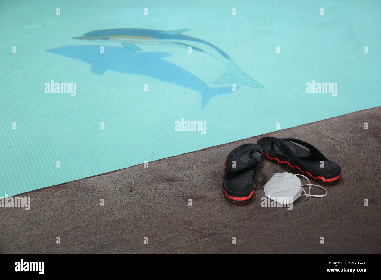 Pool to play on vacation next to flip-flops and an inflatable unicorn ...