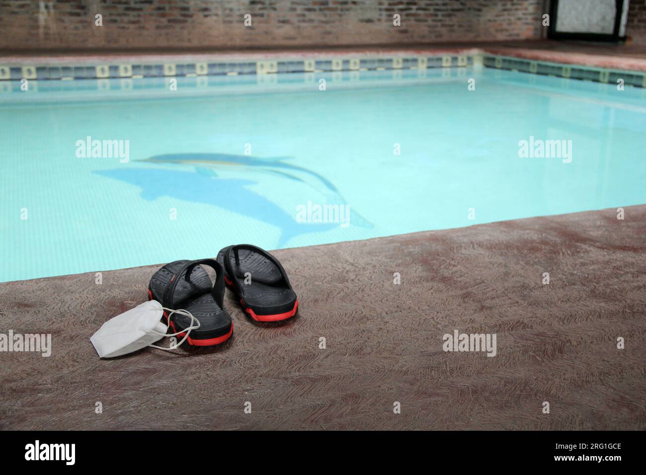 Pool to play on vacation next to flip-flops and an inflatable unicorn ...