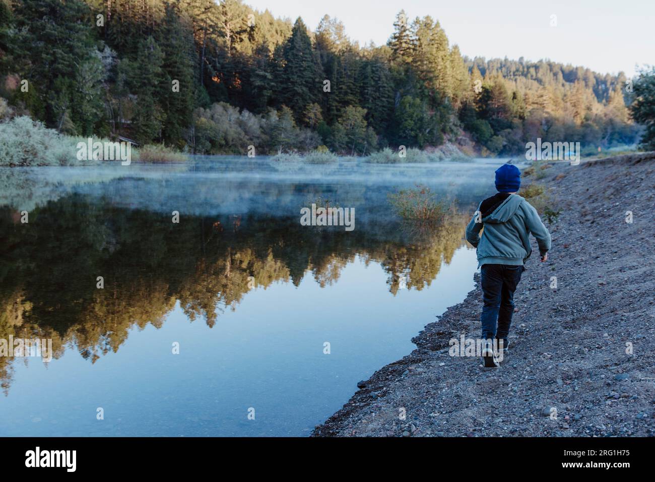 Boy running on the Rivers edge Stock Photo - Alamy