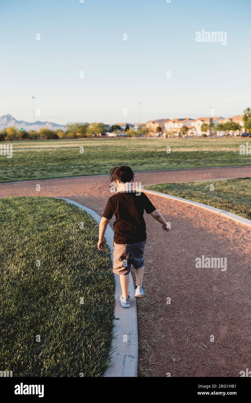 Small child walking on path Stock Photo - Alamy