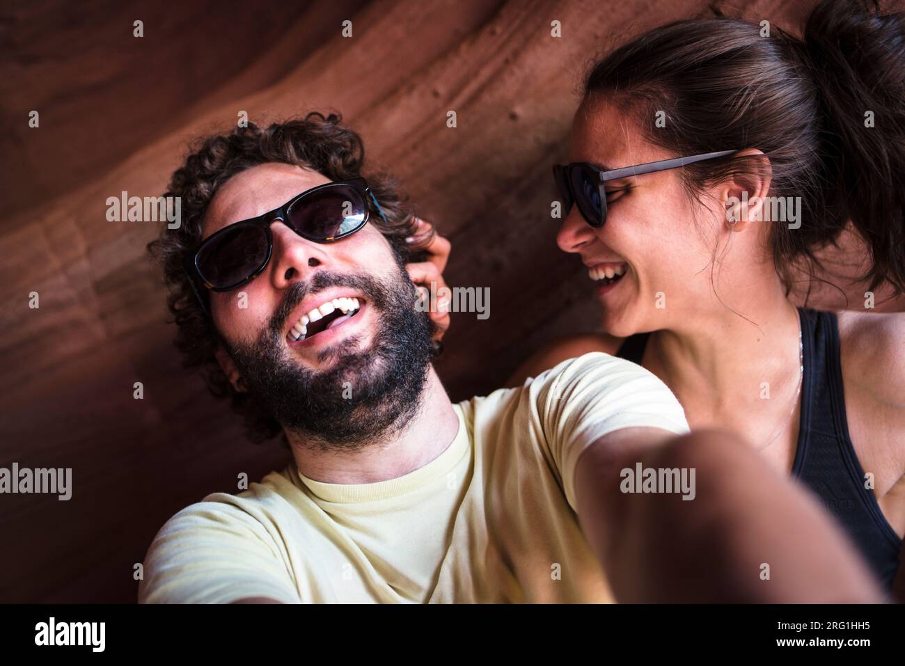 Couple with taking a selfie in a sandstone cave during a trip Stock Photo - Alamy