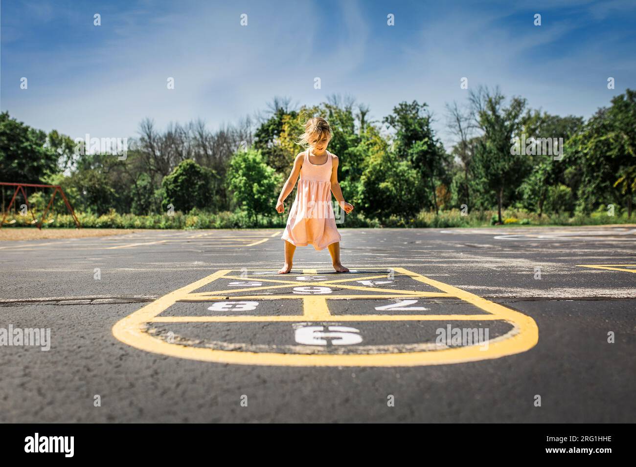 Girl playing hopscotch Stock Photo - Alamy