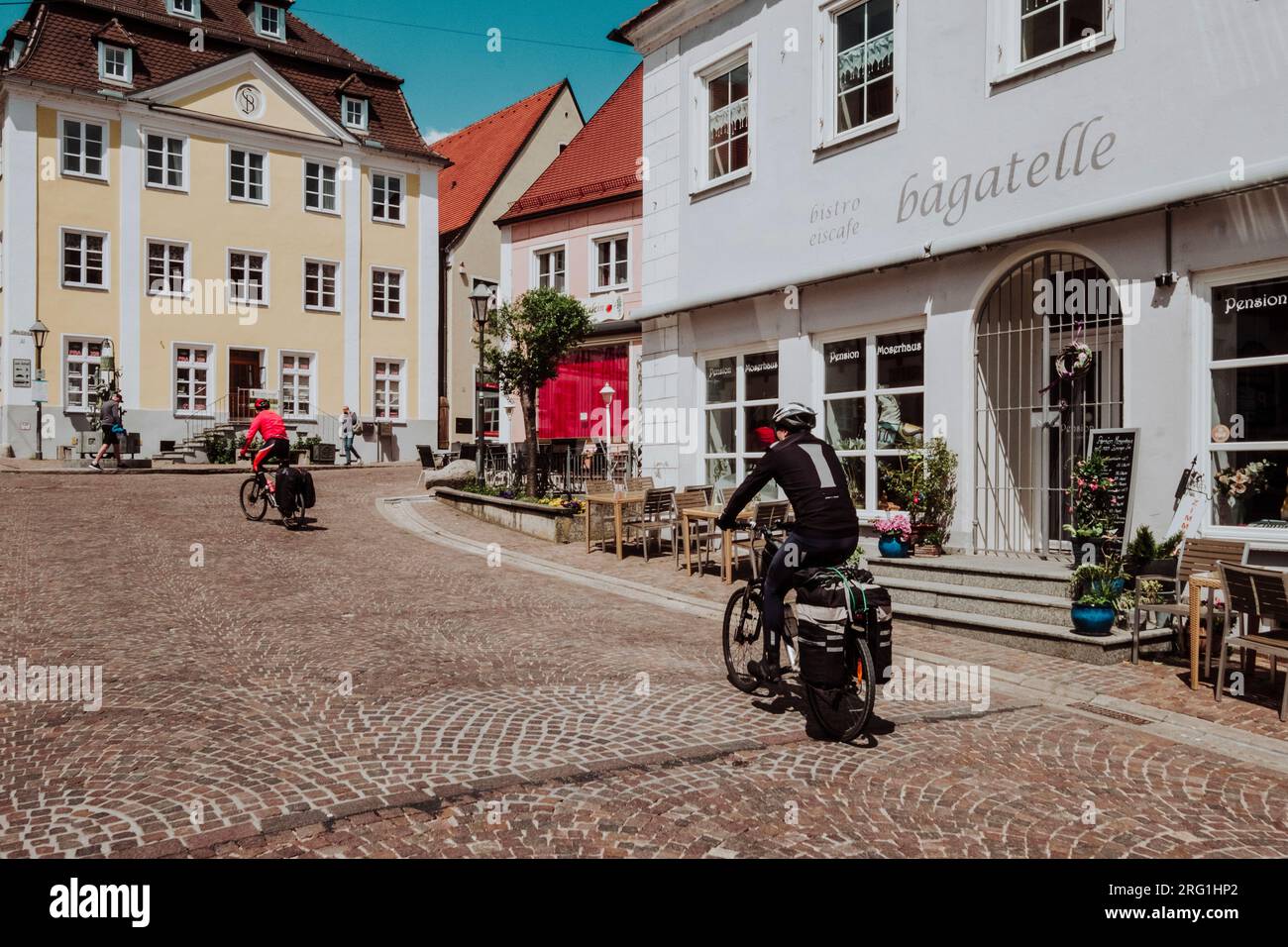 Cyclist riding his bikes in a medieval town of Romantische Straße Stock ...