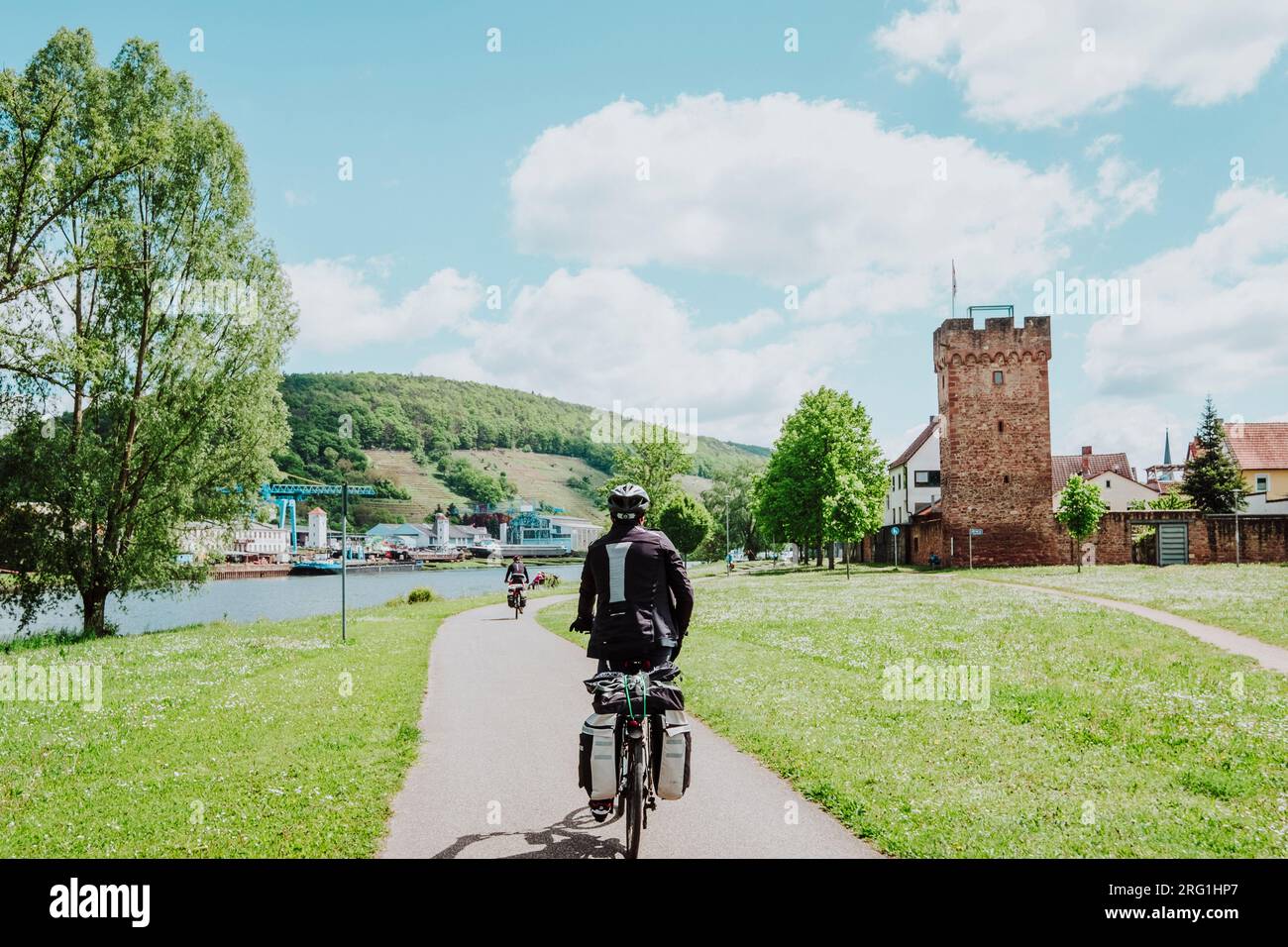 Cyclists riding his bikes near to a medieval castle Stock Photo - Alamy