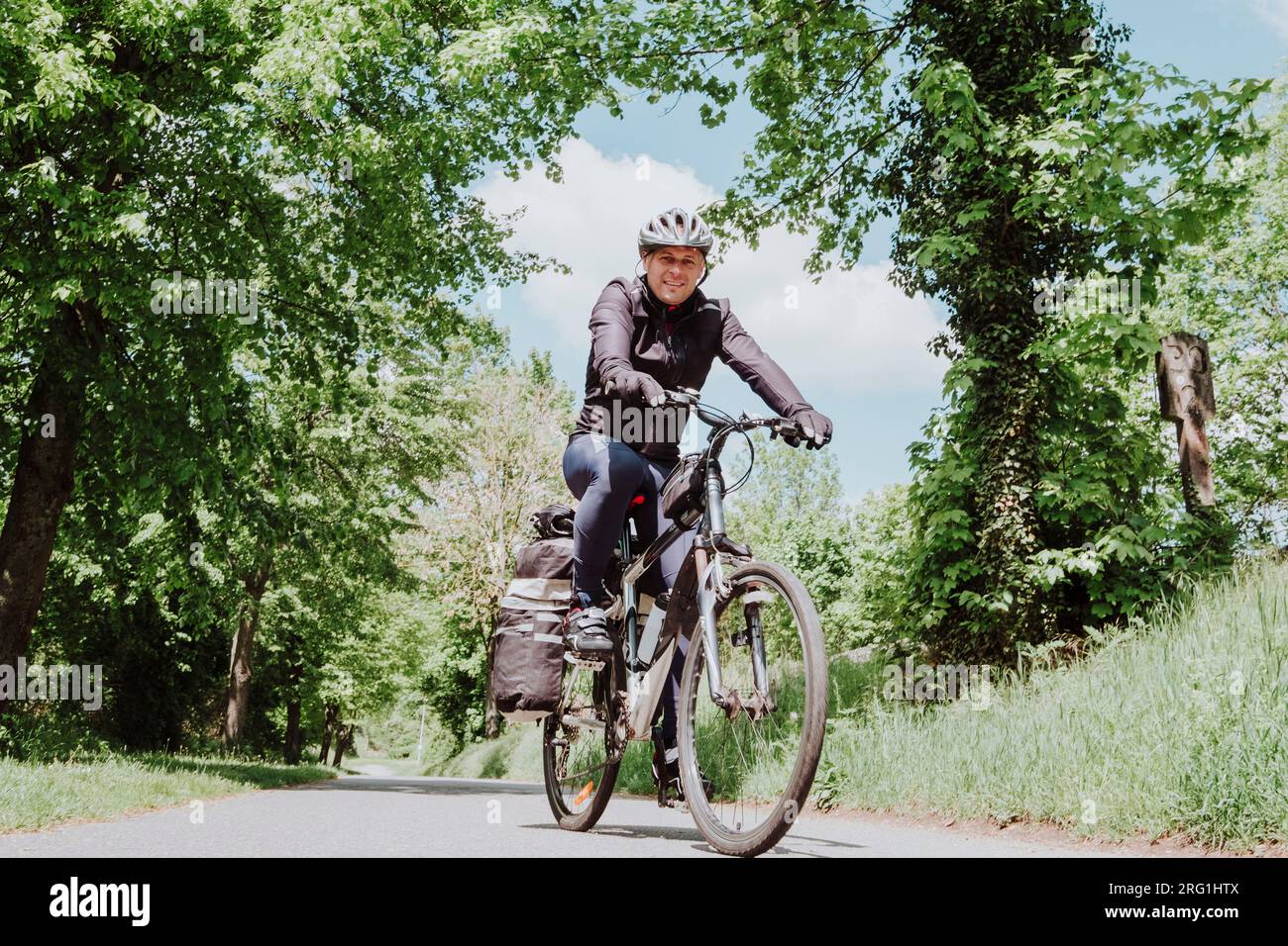 A cyclist riding his bike in a cycle line in Germany Stock Photo - Alamy