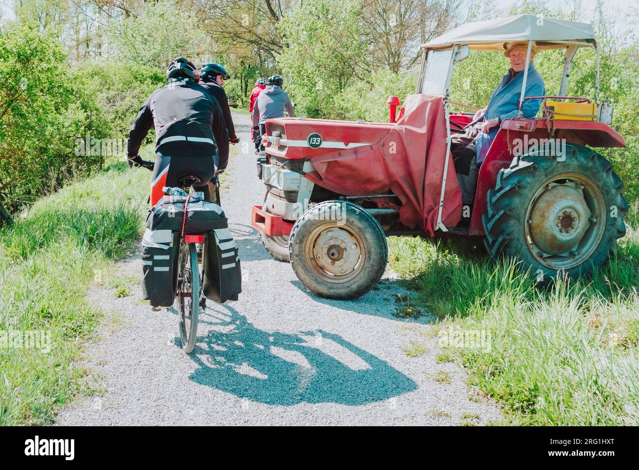 Cyclists and crawler in a cycle line in Germany Stock Photo - Alamy