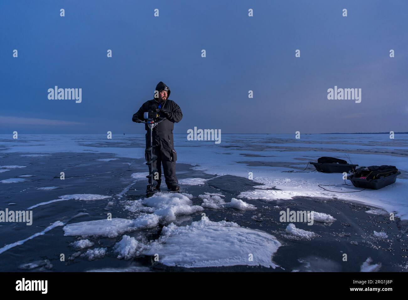 Fisherman drilling ice on frozen hi-res stock photography and images ...