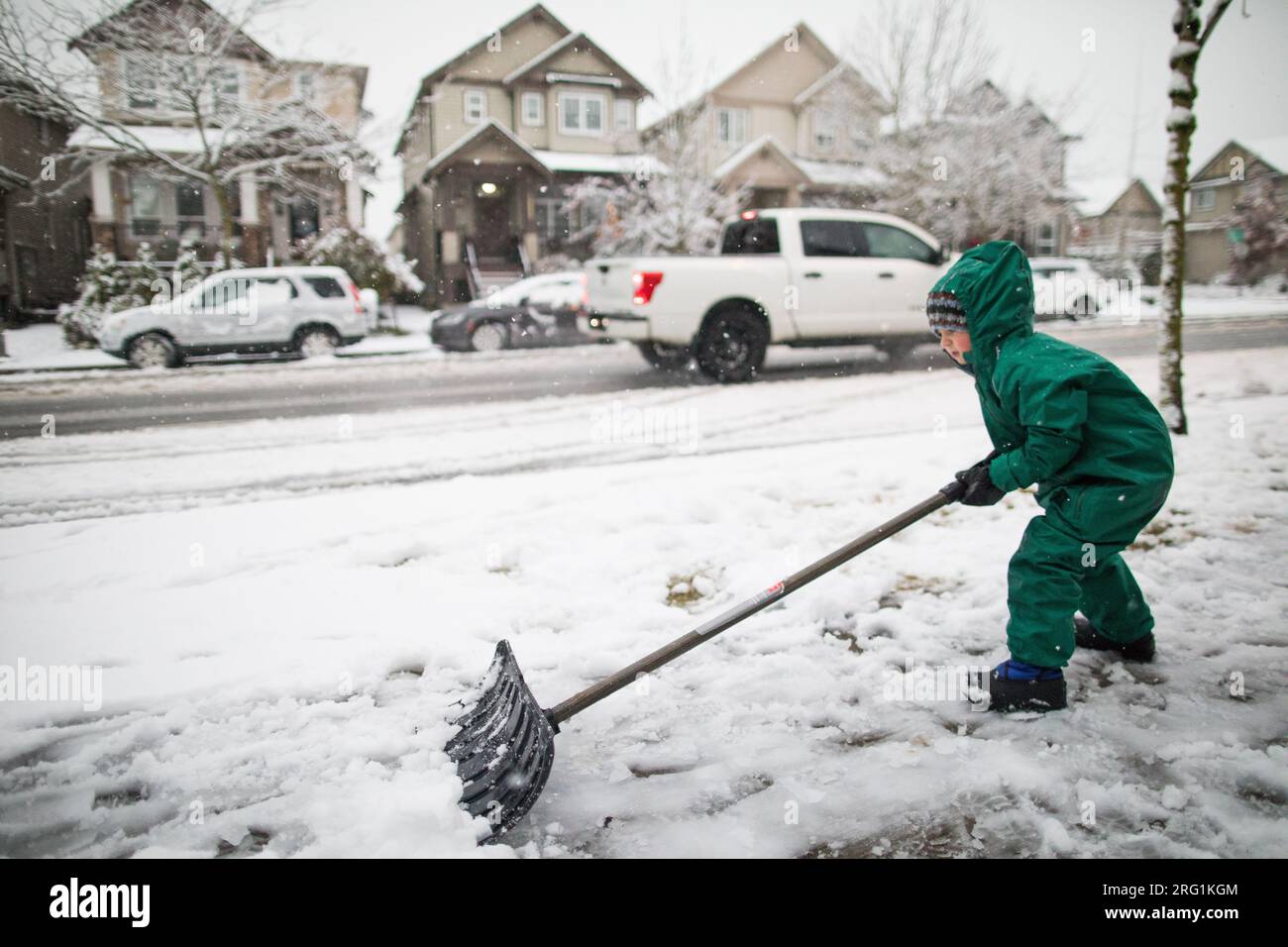strong young man shovels snow off the sidewalk Stock Photo - Alamy
