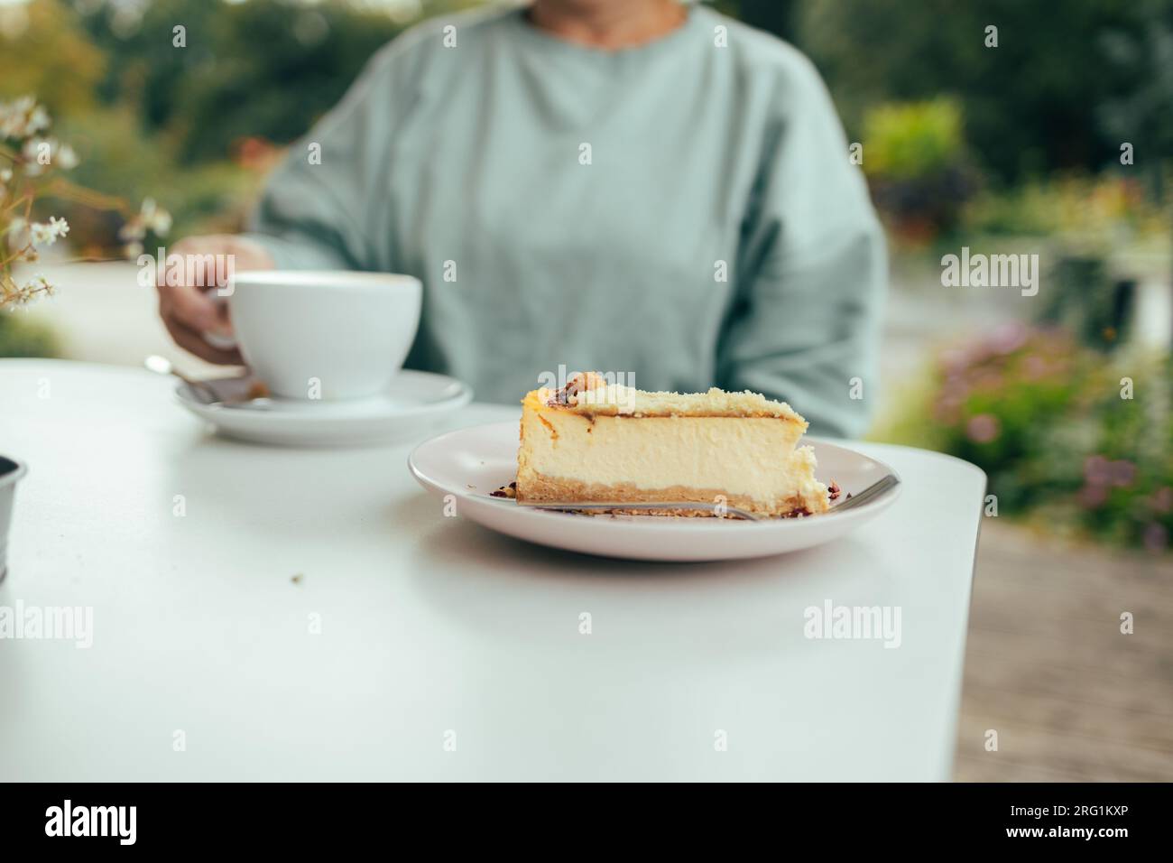 Tasty cheesecake served on white table at city cafe. Closeup image of a ...