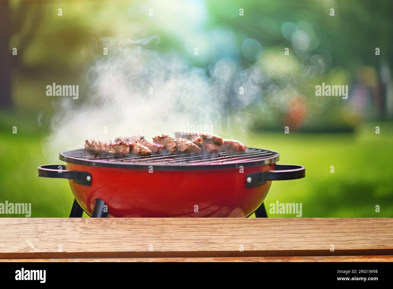 summer time party in backyard garden with grill BBQ, wooden table ...