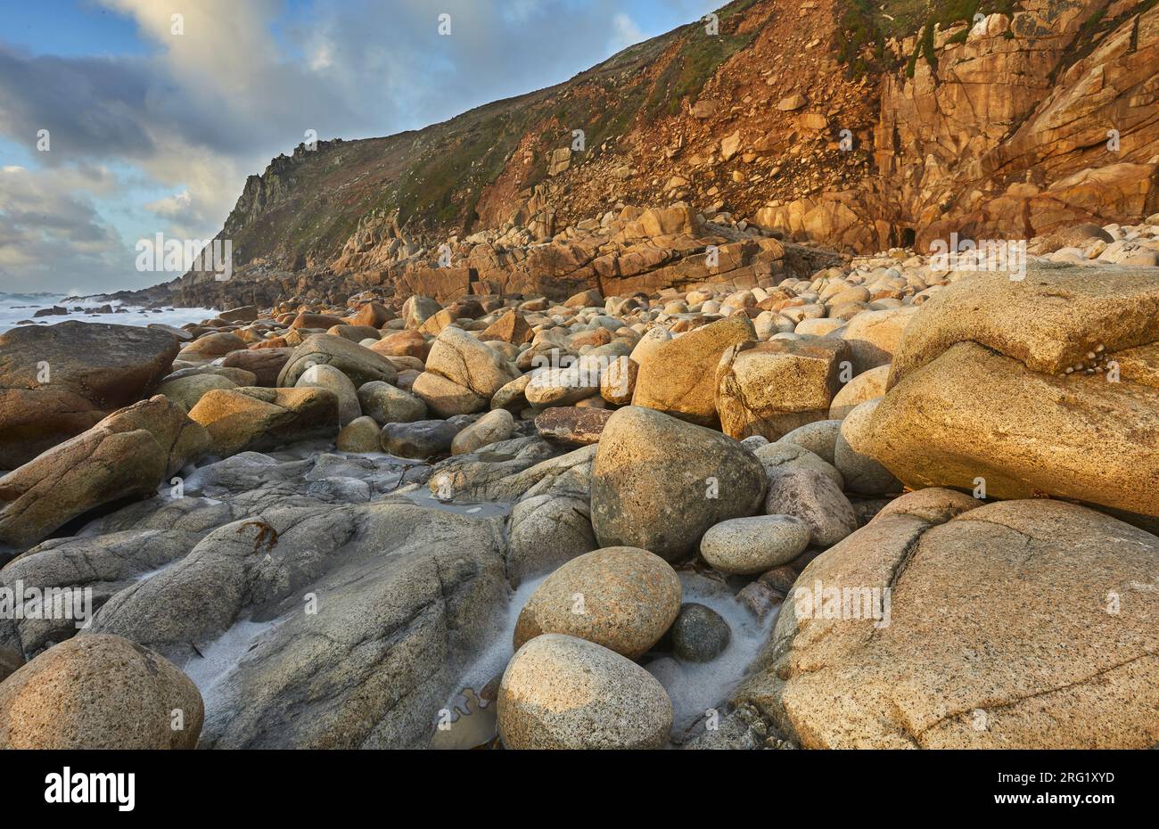 A granite boulder-strewn shore in a cove on the Atlantic coast of the ...
