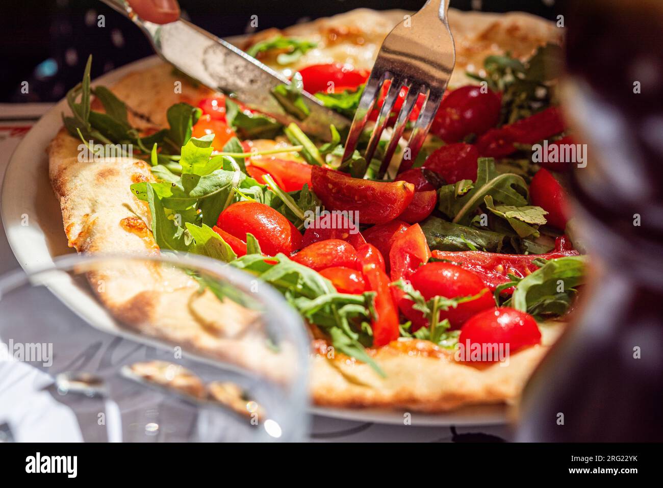 Ttraditional Roman Pizza with Tomatoes and Rugola on a white plate ...
