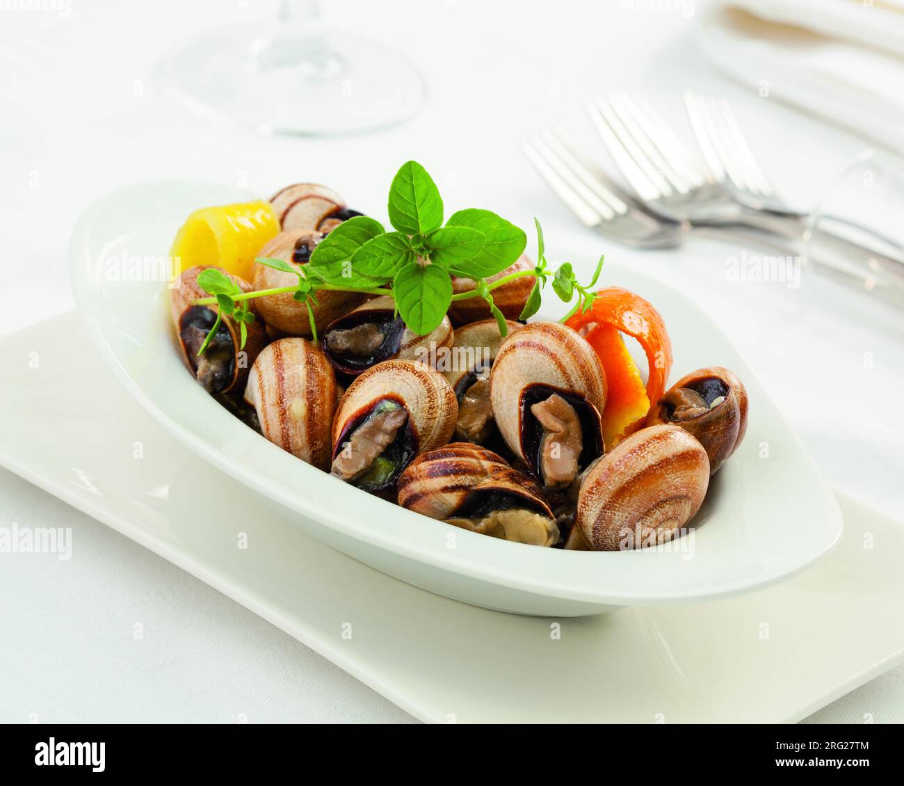 Snail escargot cooked with vegetables.Isolated on white background ...
