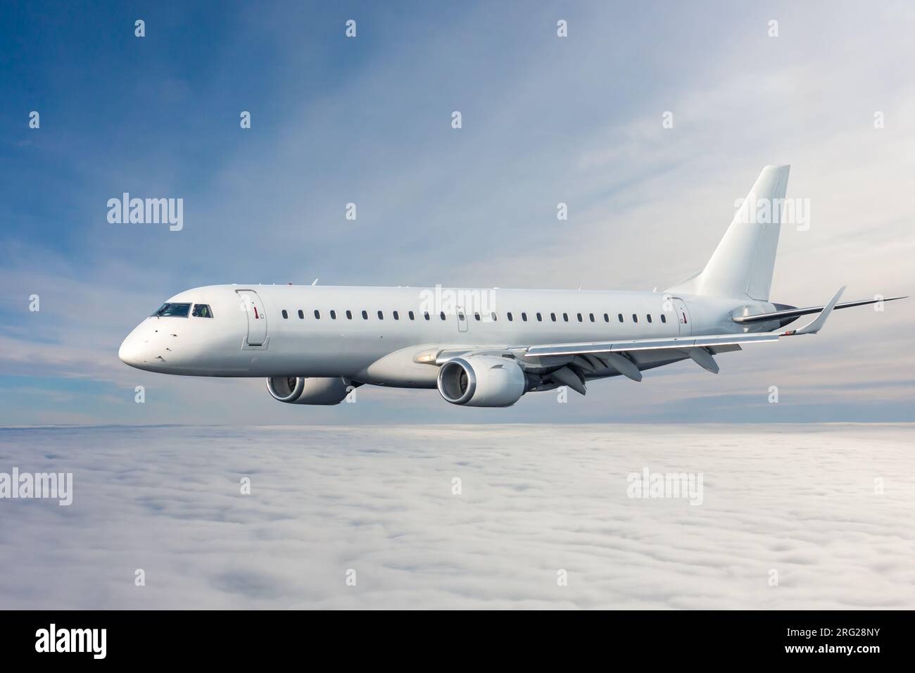 Modern white passenger jetliner flies in the sky above the clouds Stock ...