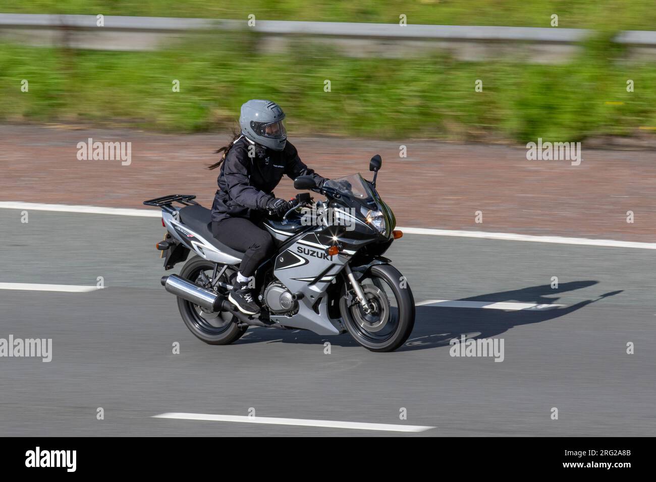 SUZUKI silver GS500 travelling at speed on the M6 motorway in Greater ...