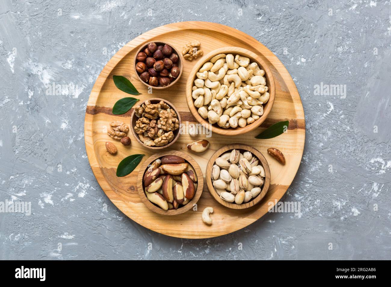 mixed nuts in wooden bowl. Mix of various nuts on colored background ...